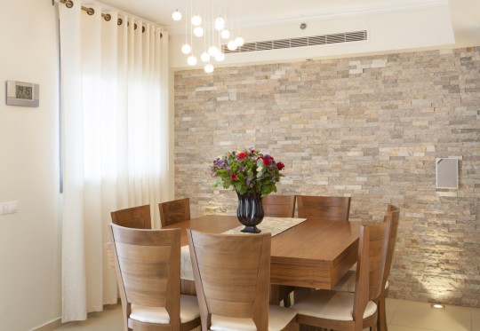 Wood dining room table with stone wall - Interior Design Ideas